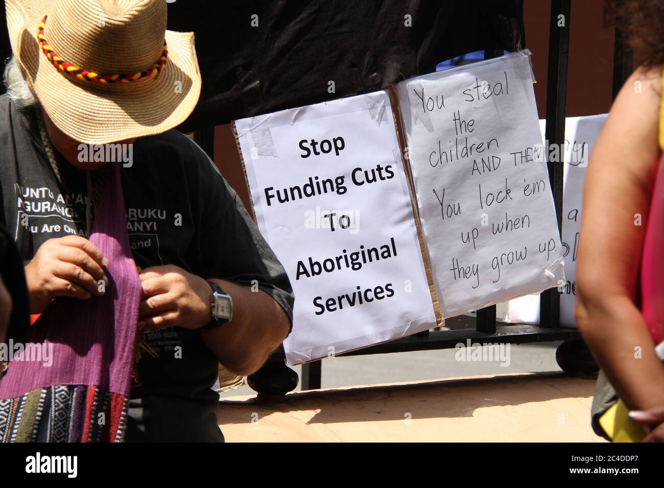 Signs at the rally included ‘Stop Funding Cuts To Aboriginal Services ...