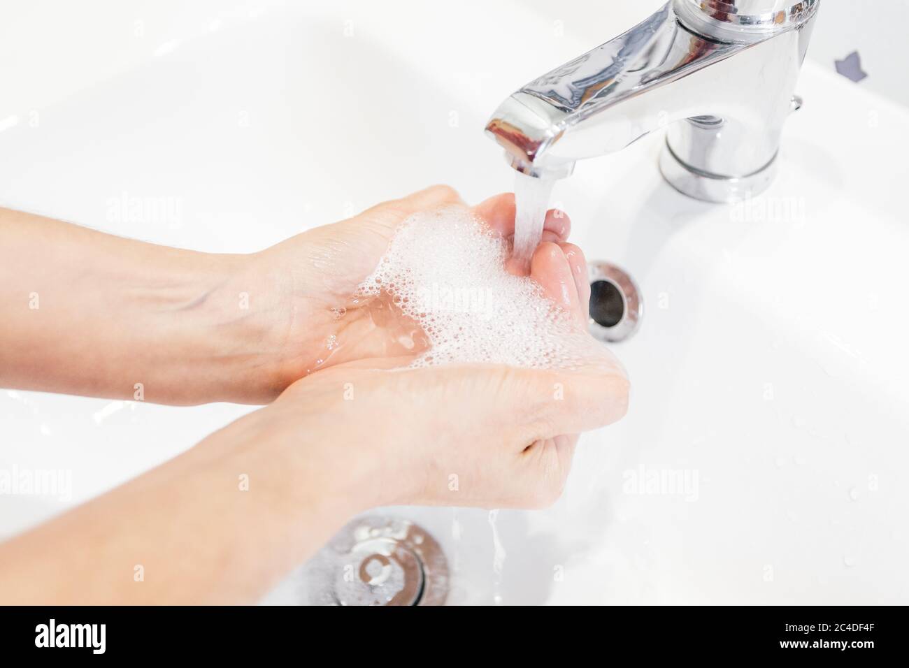 Person washing his hands hygienically with soap under the tap Stock ...