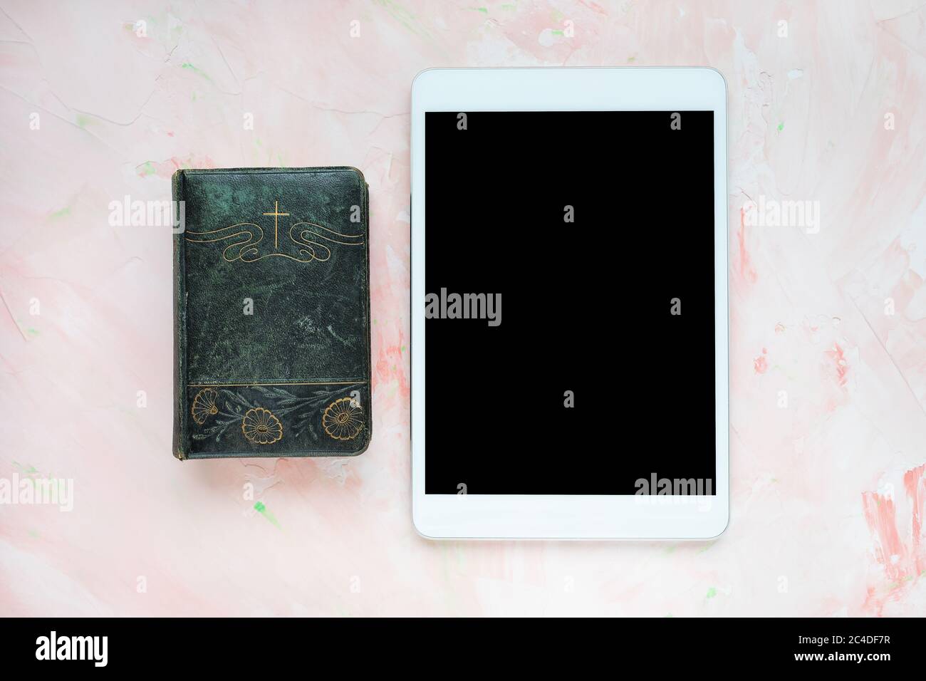 Bible and tablet on pink, christian background Stock Photo - Alamy