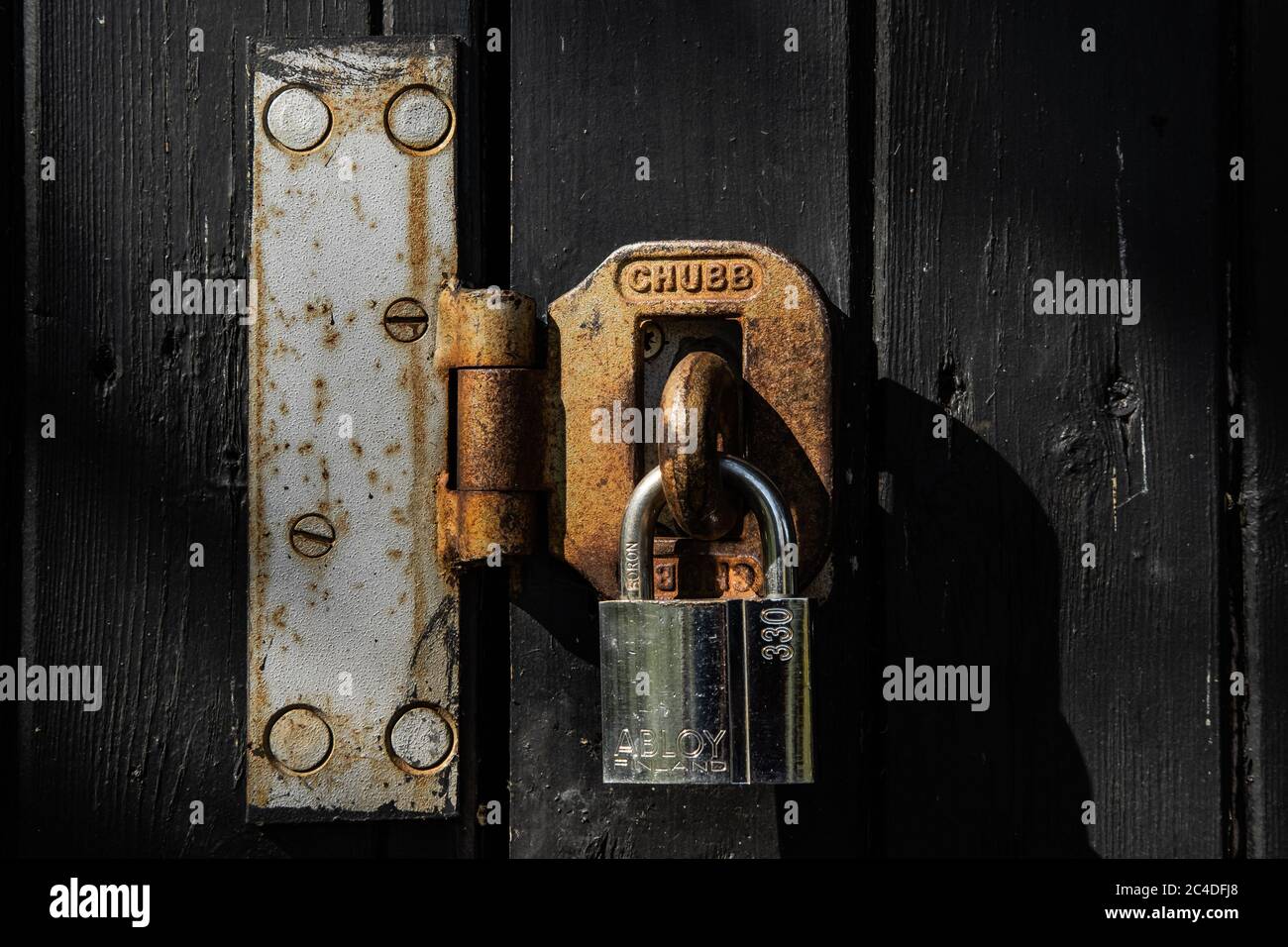 Isolated view of an old, rusting metal shackle seen together with a ...
