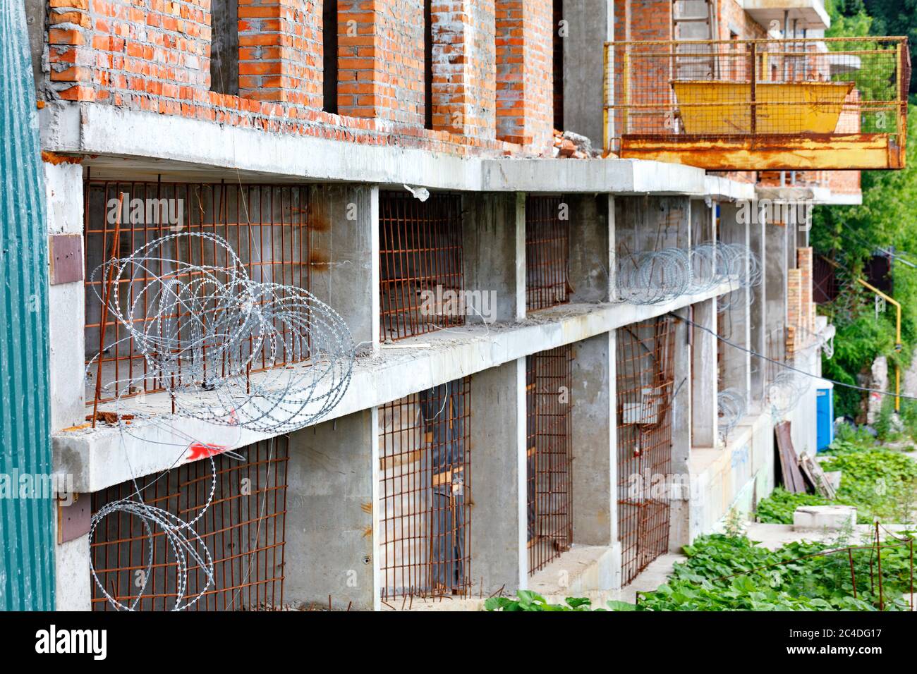 barbed-wire-and-rusty-iron-rods-prevent-entry-into-an-abandoned-construction-site-in-the