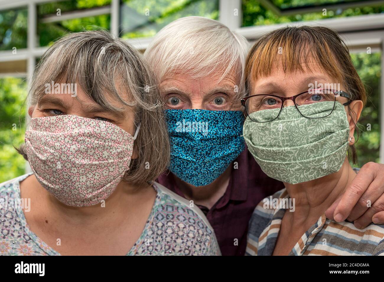 Family with face masks on against the Corvid-19 virus during lockdown ...