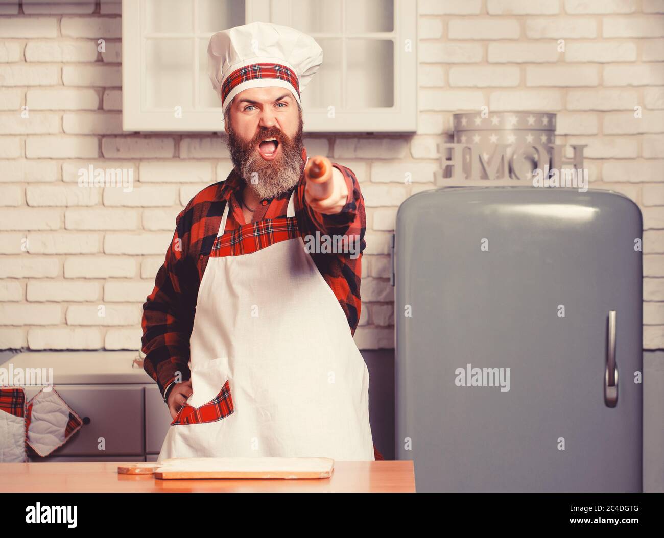 Young handsome cook man celebrating mad and crazy for success with arms ...