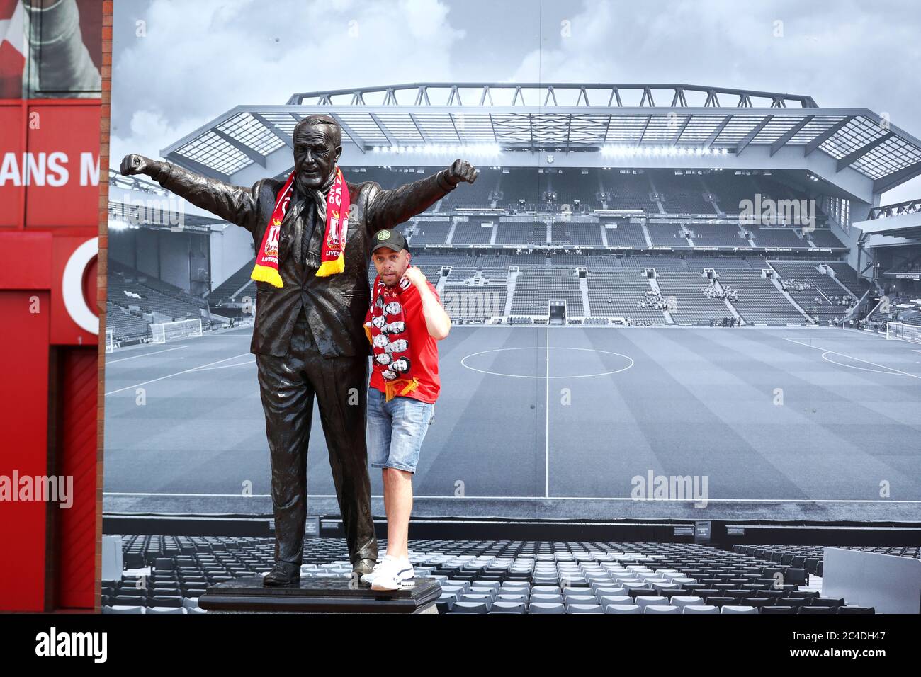 Liverpool fan Anthony Furns poses for a photo with the Bill Shankly ...