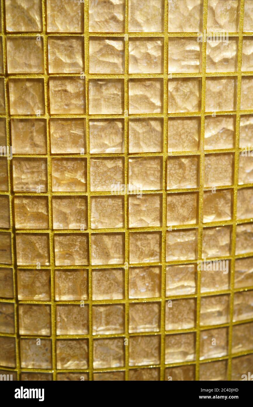 Checkered texture of the glass blocks. Golden-colored glass or mosaic ...