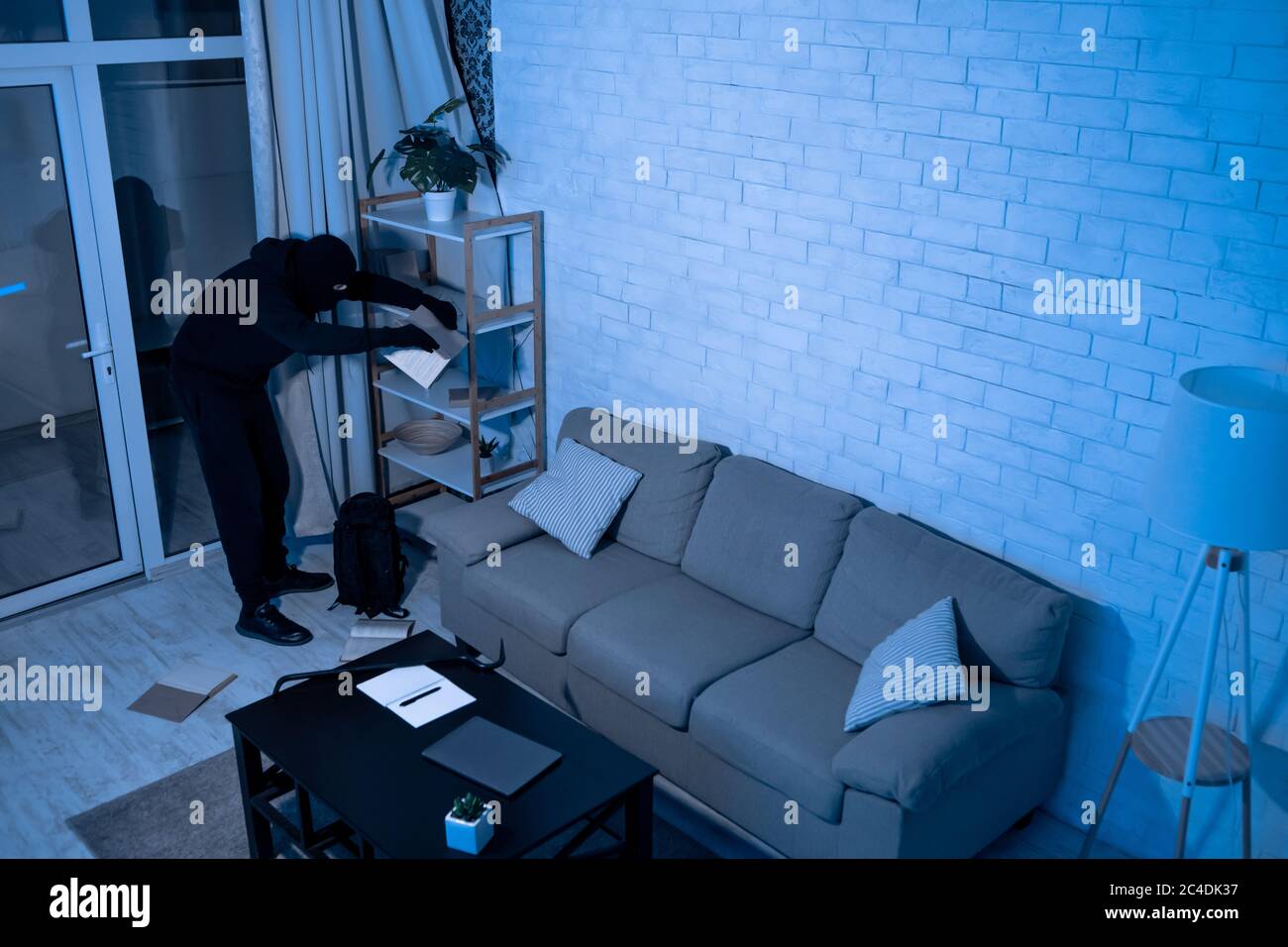 Intruder breaking in an apartment or office stealing money Stock Photo ...