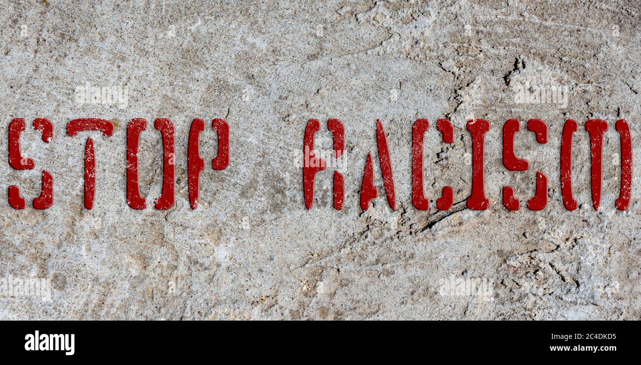 Stencil stop racism on an old concrete wall. Background. Collage ...