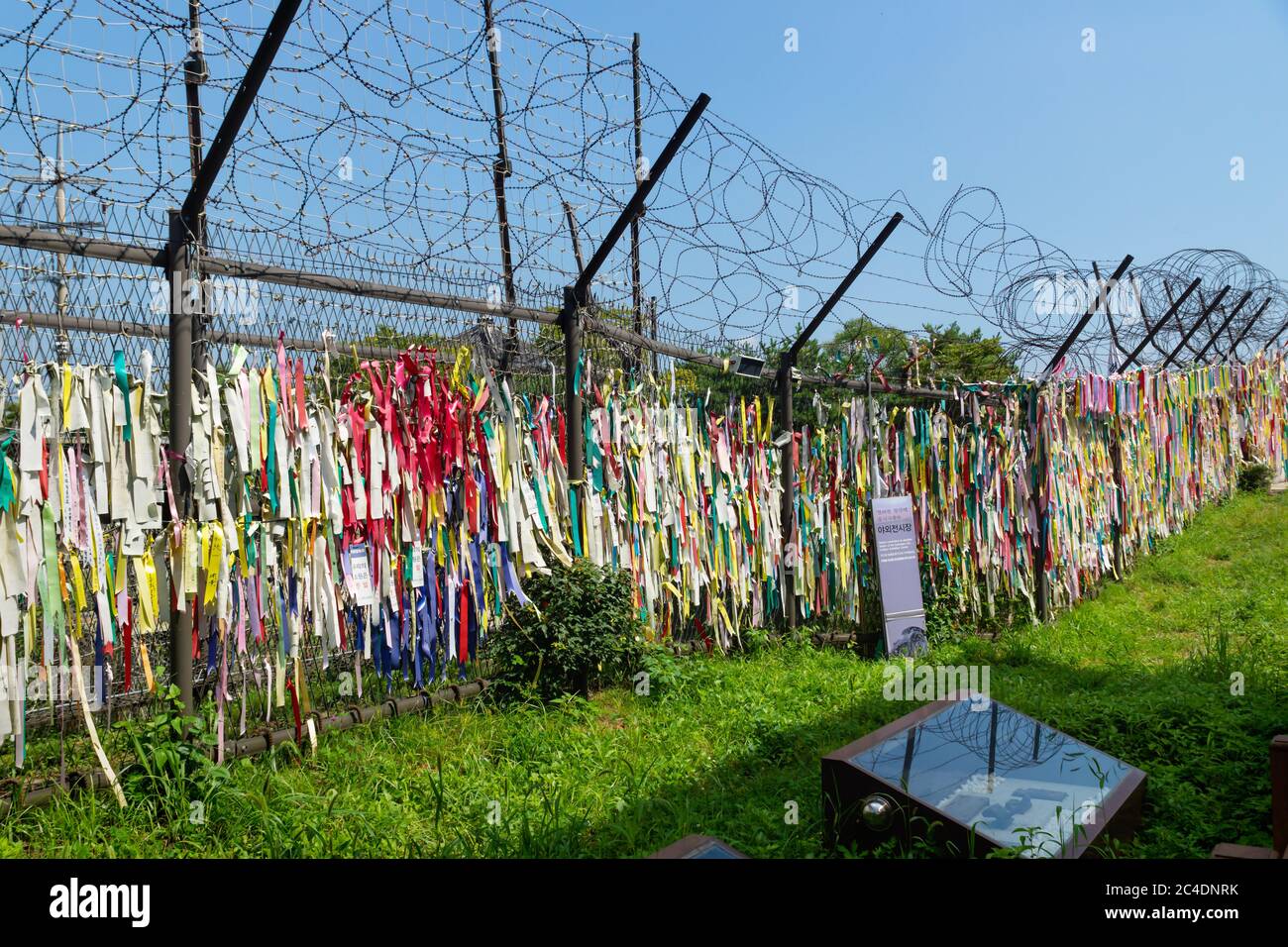 Prayer ribbons tied to the barbed wire fence left by visitors wishing ...