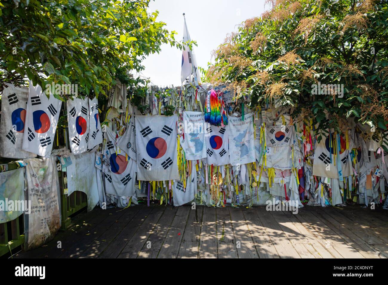 Prayer ribbons and flags tied to the fence left by visitors wishing ...