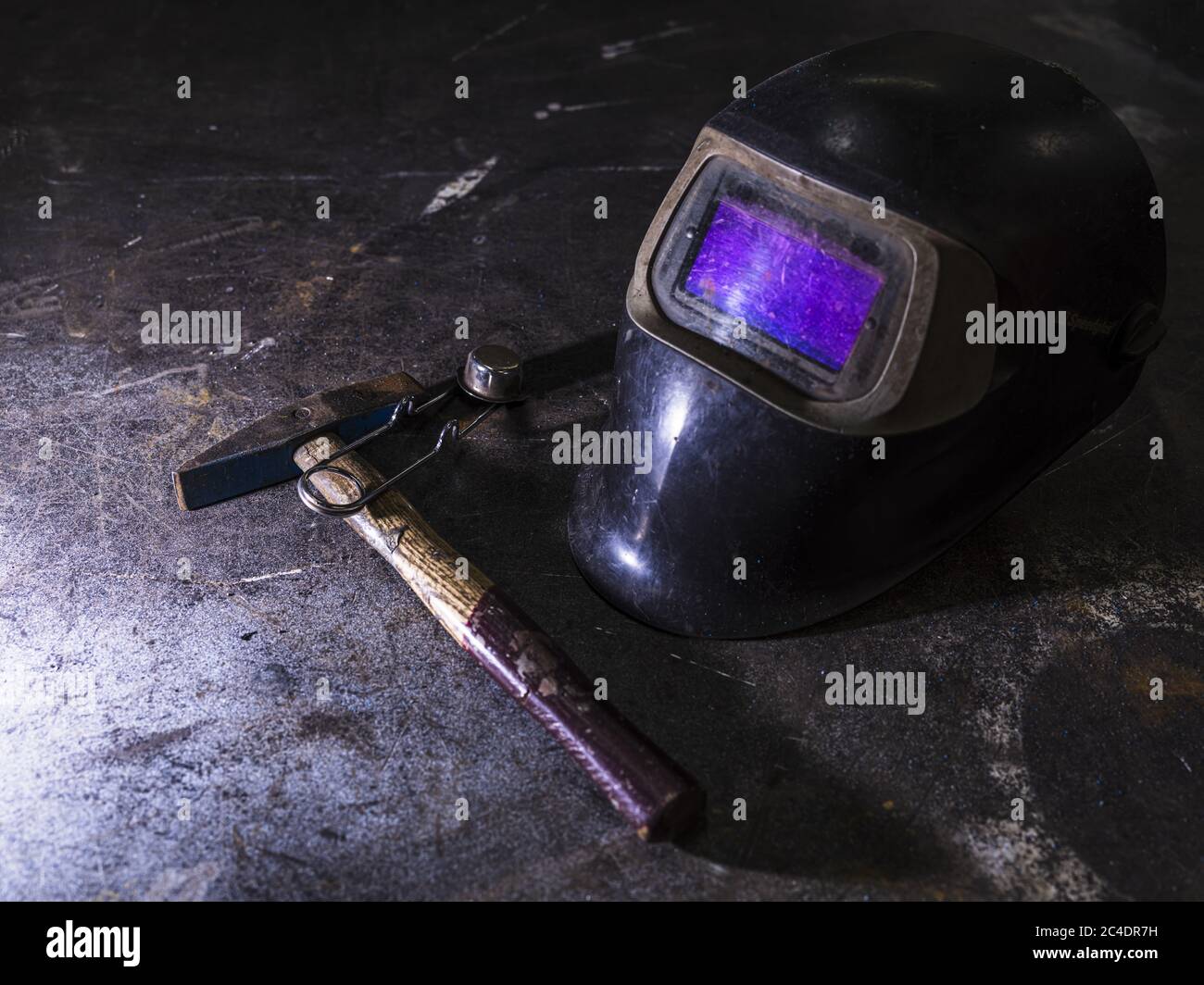 Closeup shot of a welding helmet near a hummer Stock Photo - Alamy