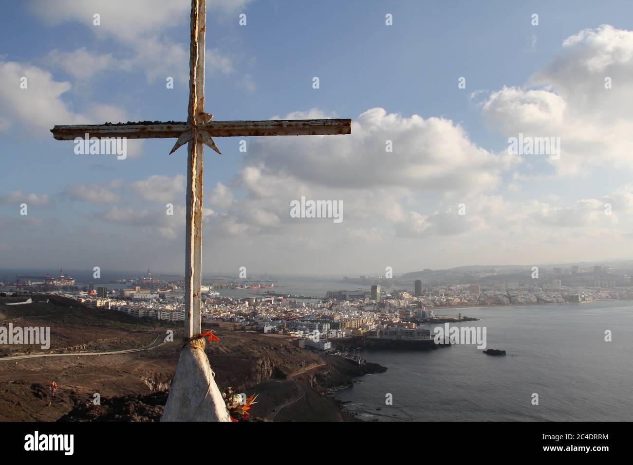 Aerial shot of a metal cross on a building dome on a coastal city ...