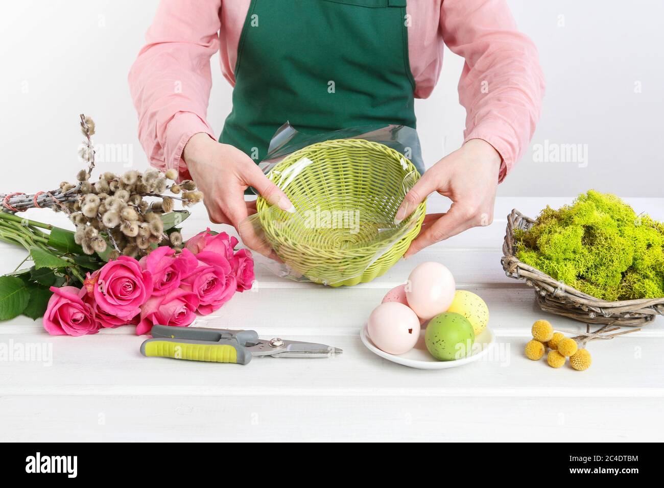 Florist at work: woman shows how to make Easter table decoration with ...