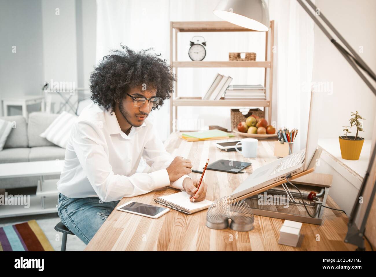 Smart arabic guy writting in notebook. Young student or entrepreneur ...