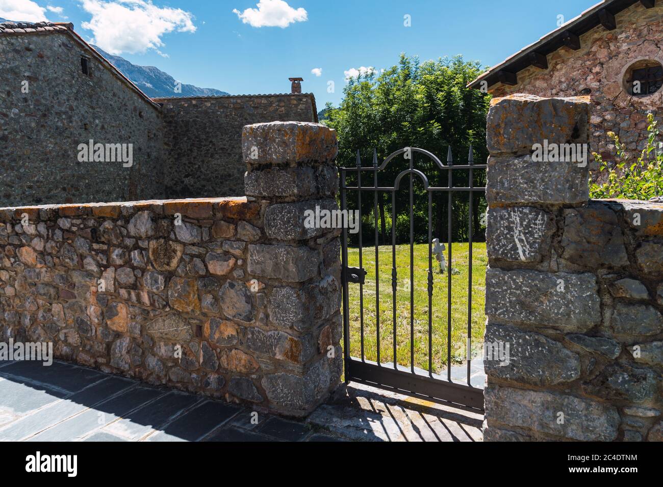 Gate of a very small cemetery in a village in the Pyrenees mountains ...