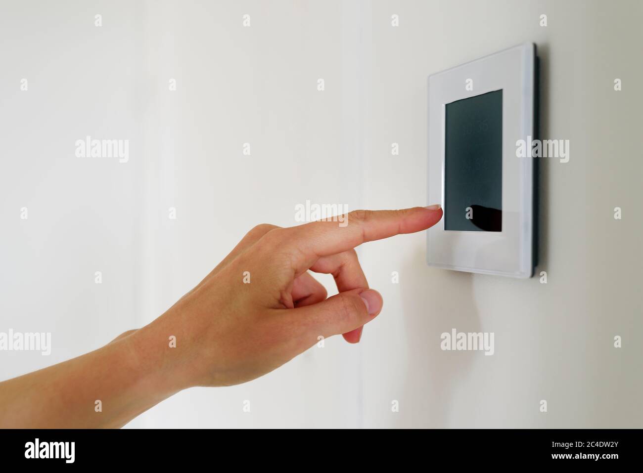 Hand using Air ventilation controller panel with display at home. Smart ...