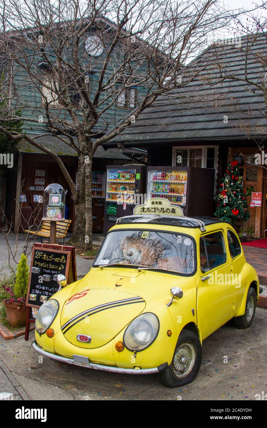 a old subaru 360 yellow taxi was converted to an art craft to attract ...