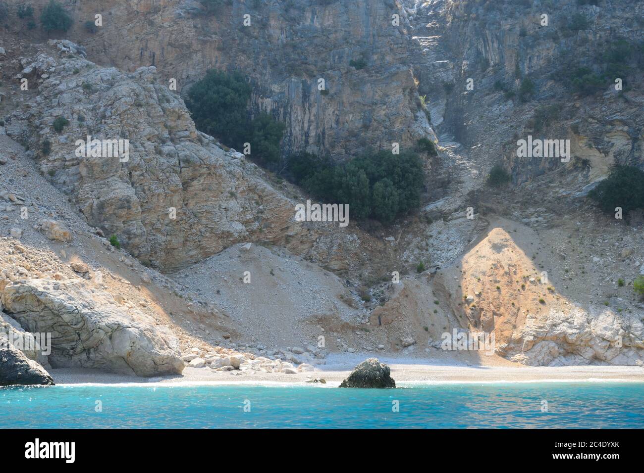 Eroding Cliff in Fethiye Hanging Over a Secluded Beach Stock Photo - Alamy
