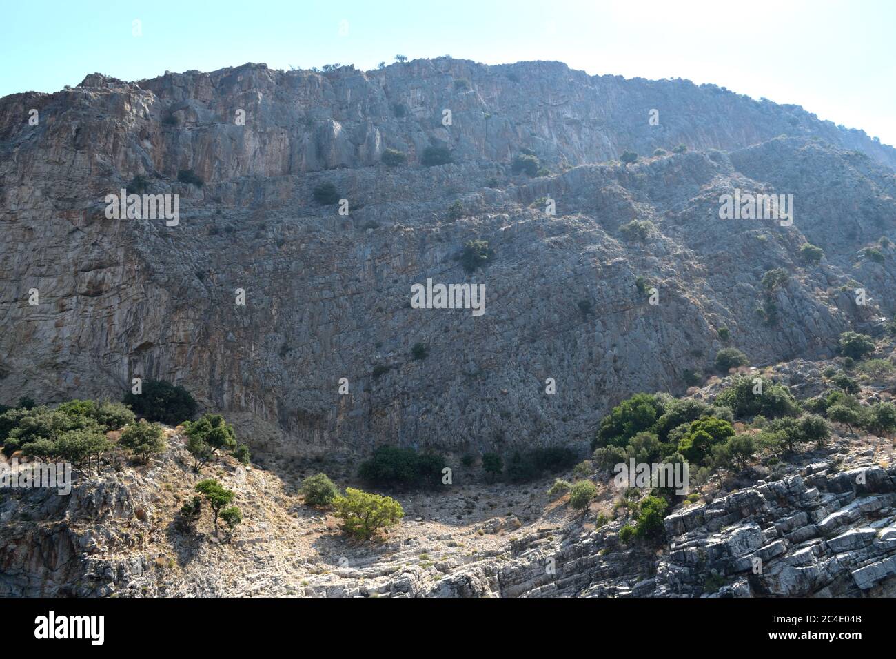A Tall Crumbling Cliff in Fethiye Revealing Layers of Rock Stock Photo ...