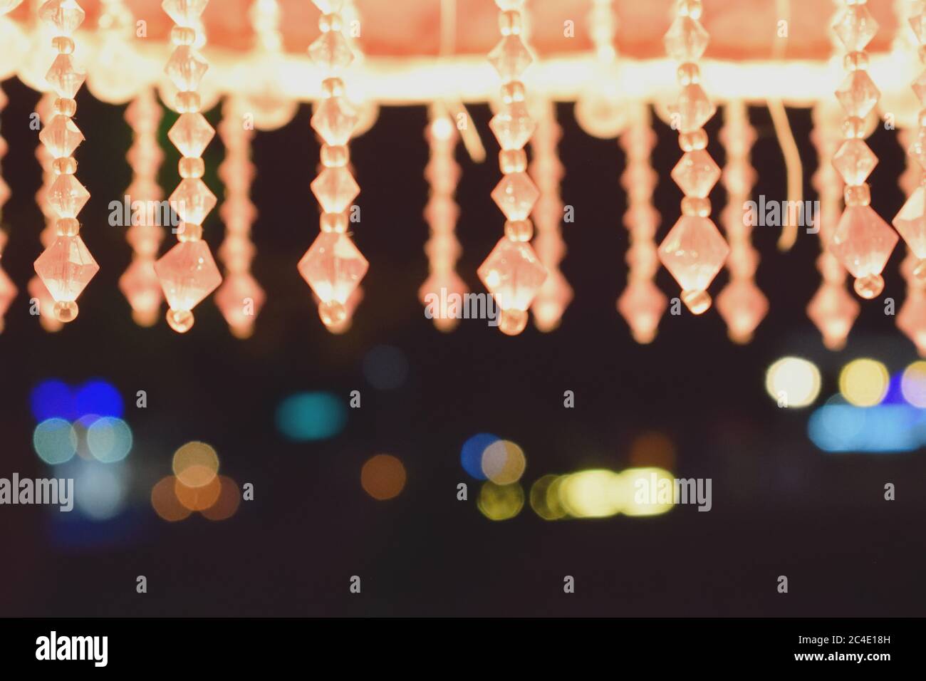 Blurred Party Lights Behind an Outdoor Lamp with Hanging Crystals Stock ...