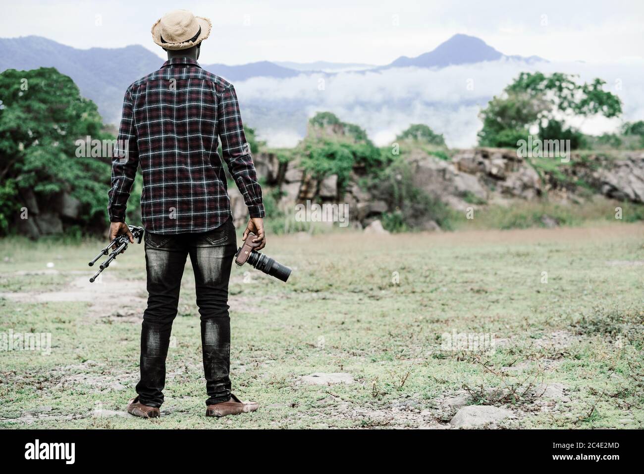 African man photography holding the camera and tripod Stock Photo - Alamy