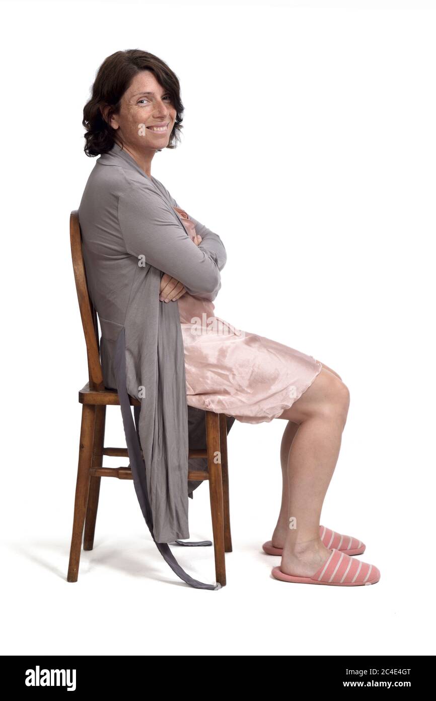 side view of a woman sitting dressing gown on white background Stock ...