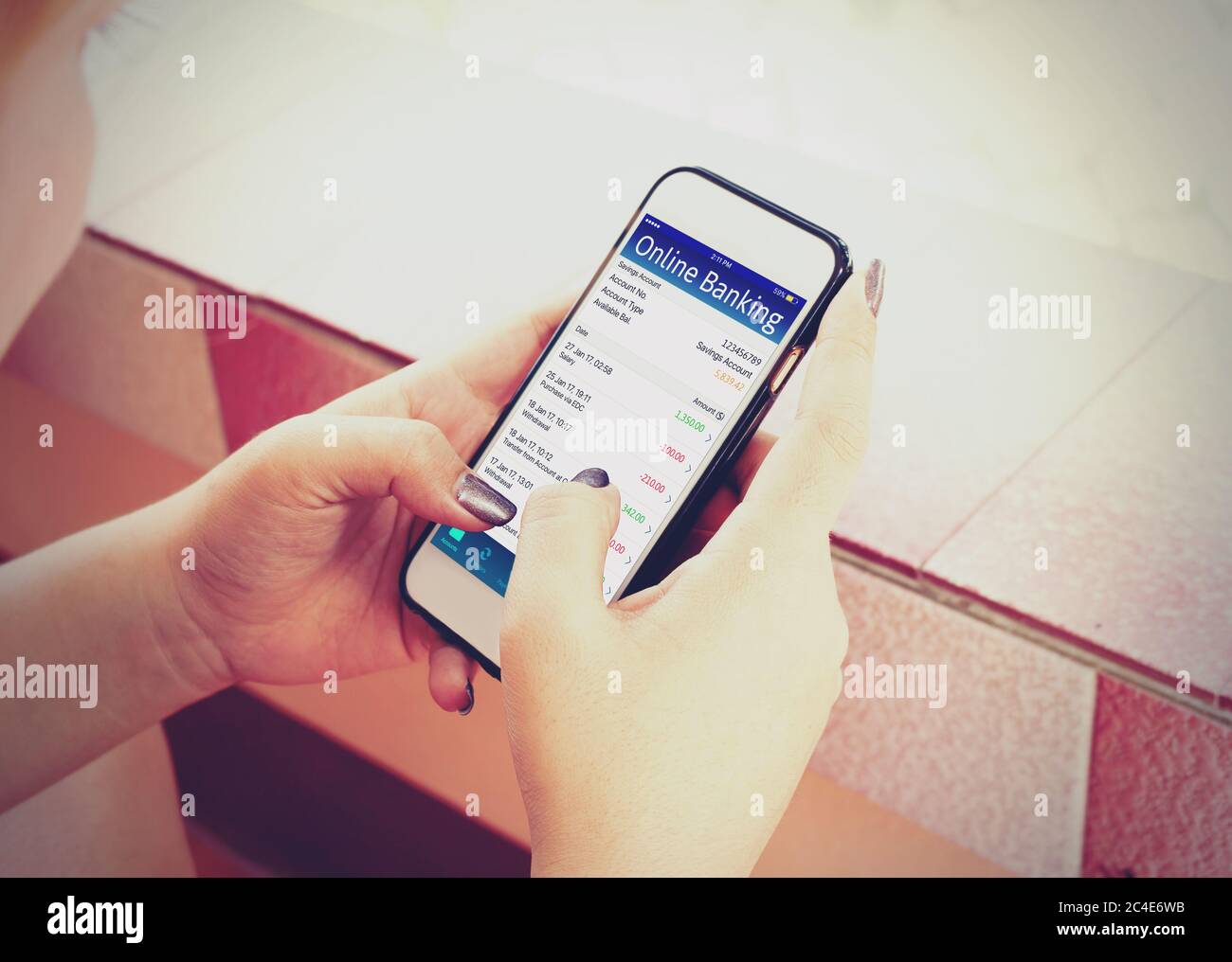 Young woman using mobile banking with smartphone Stock Photo - Alamy