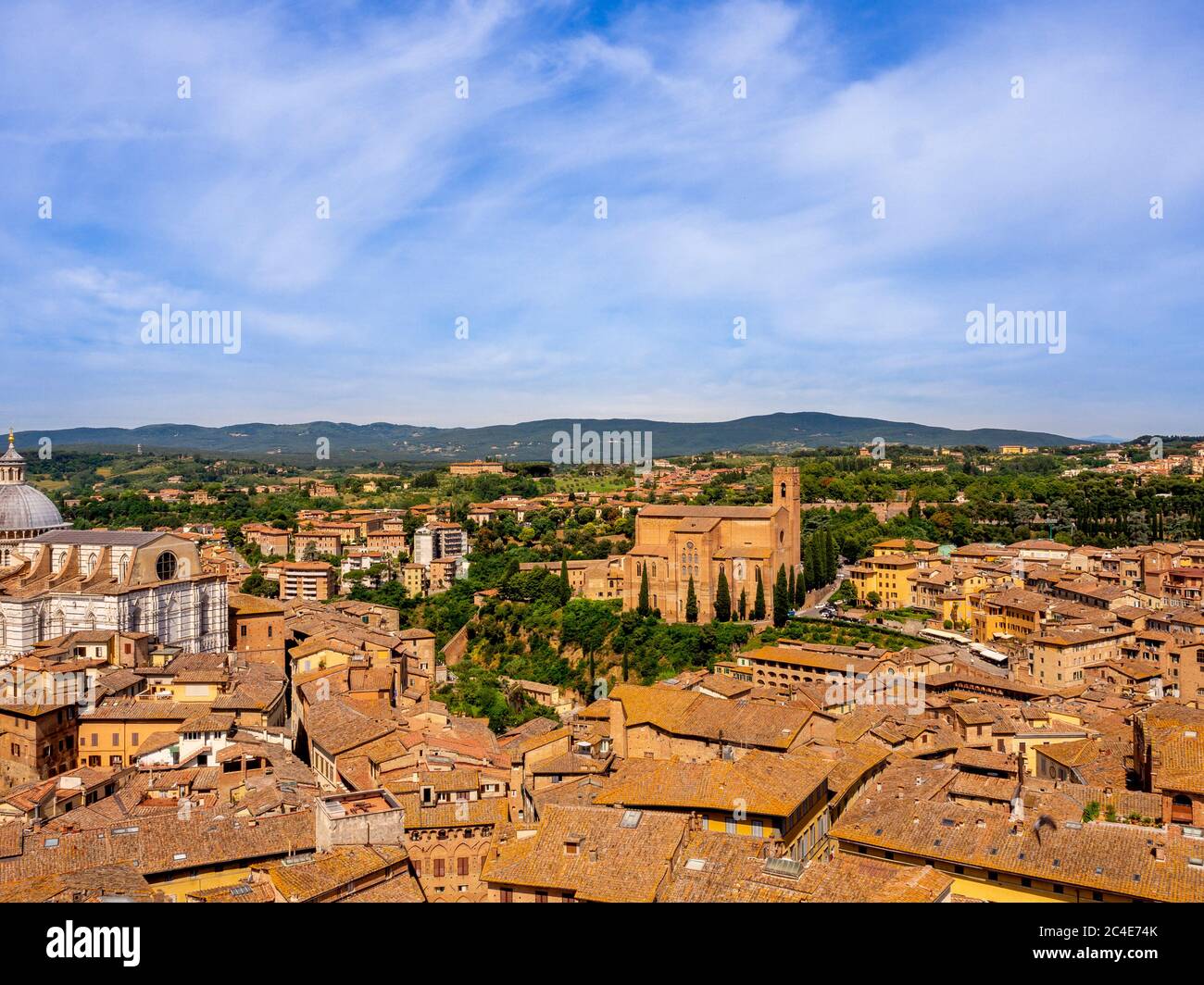 Aerial view of Siena cathedral and surrounding terracotta rooftops ...