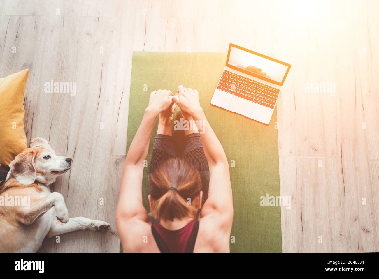 Top view at fit sporty healthy woman sit on mat in Paschimottanasana ...