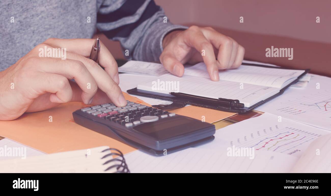 Young man calculate about cost and doing finance in home Stock Photo ...