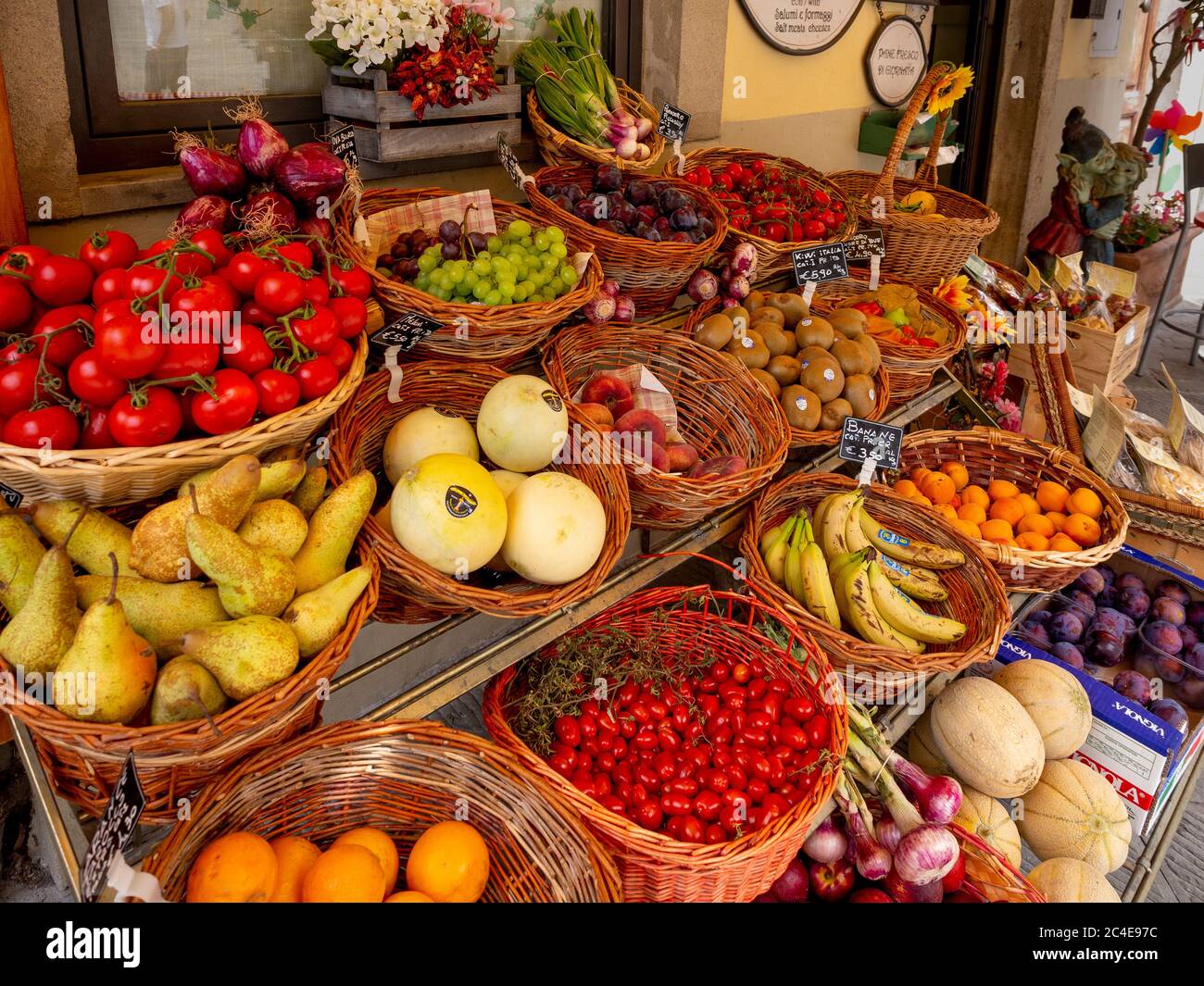 Fresh fruit and vegetables displayed in baskets outside an italian ...
