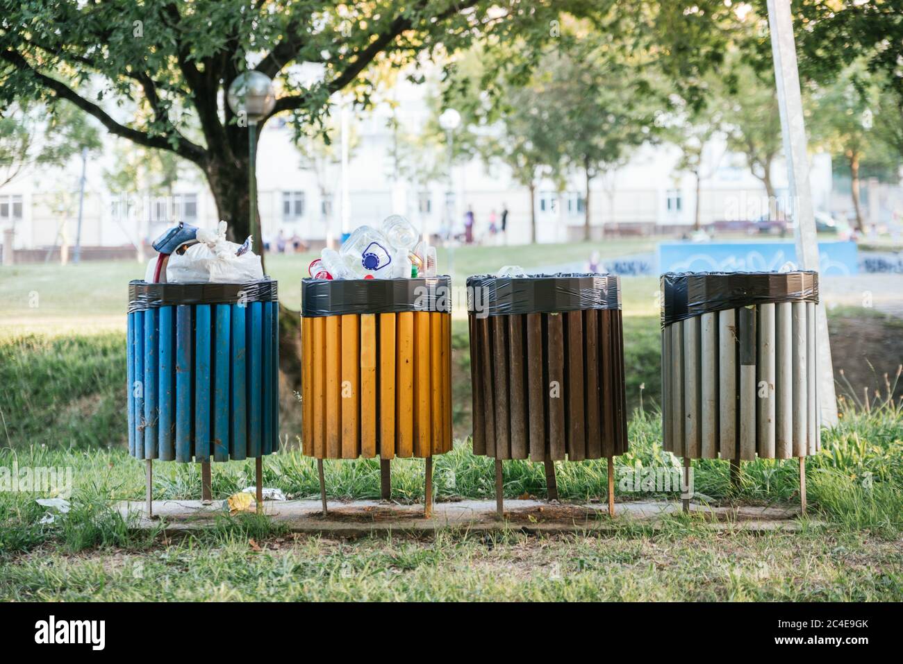 Landscape shot of colorful garbage bins outside promoting clean ...