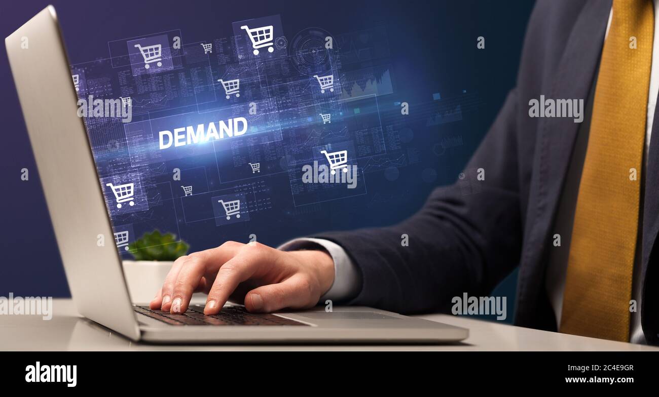 Businessman working on laptop with DEMAND inscription, online shopping ...