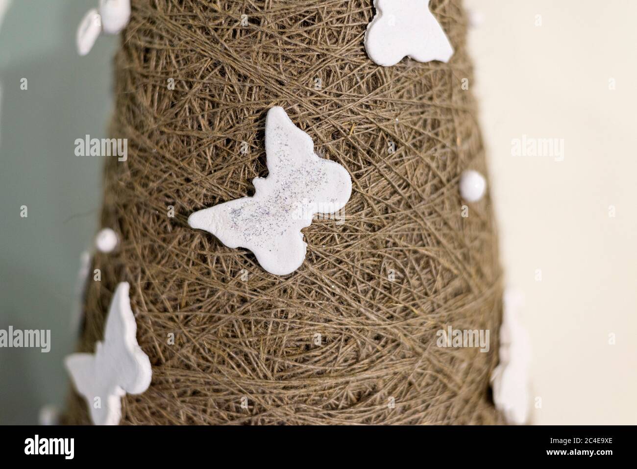 Creative background: white butterflies made of plaster on a cone of ...