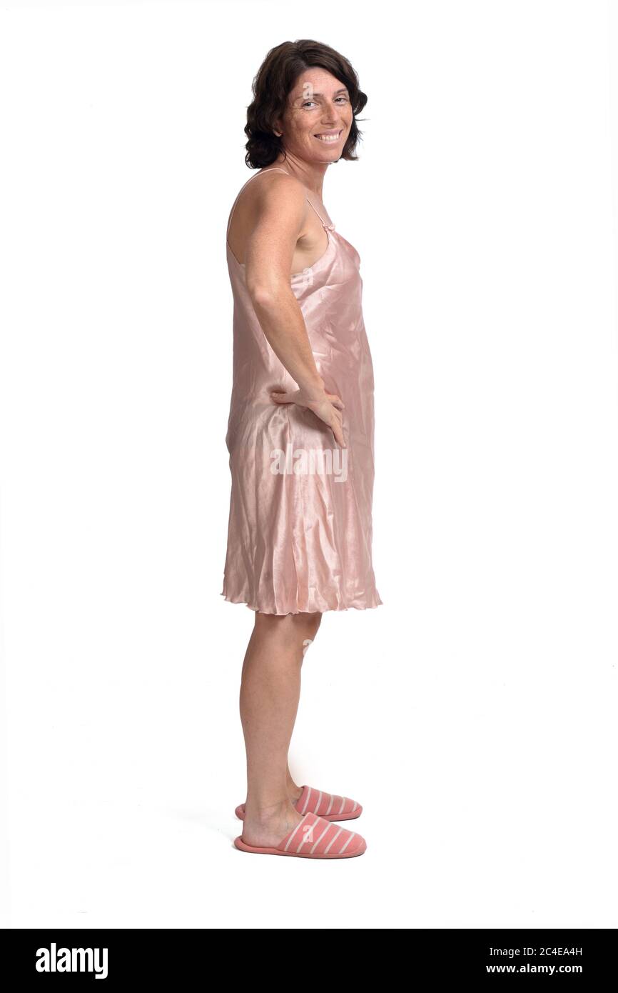side view of summer nightgown on white background, hands on hip looking ...