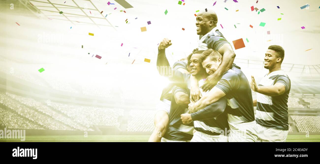 Digital composite image of team of rugby players celebrating a win in ...