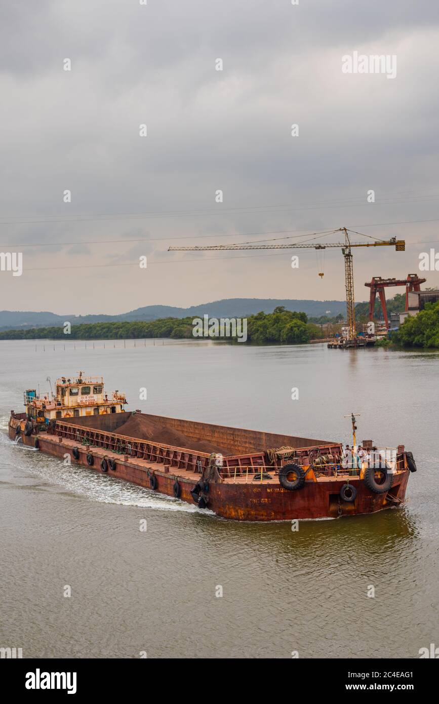 SOUTH GOA, INDIA - May 05, 2020: Barges carrying mining ore for export ...