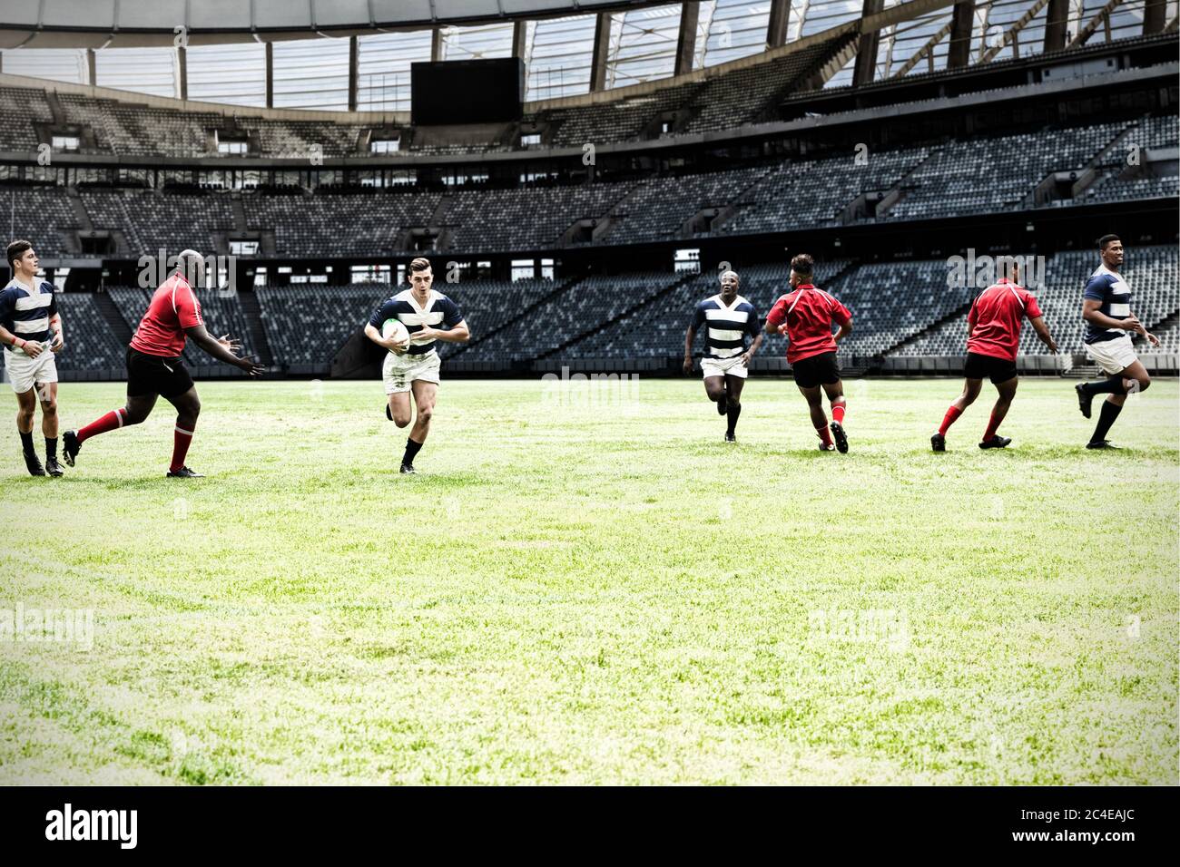 Digital composite image of team of rugby players playing rugby in ...