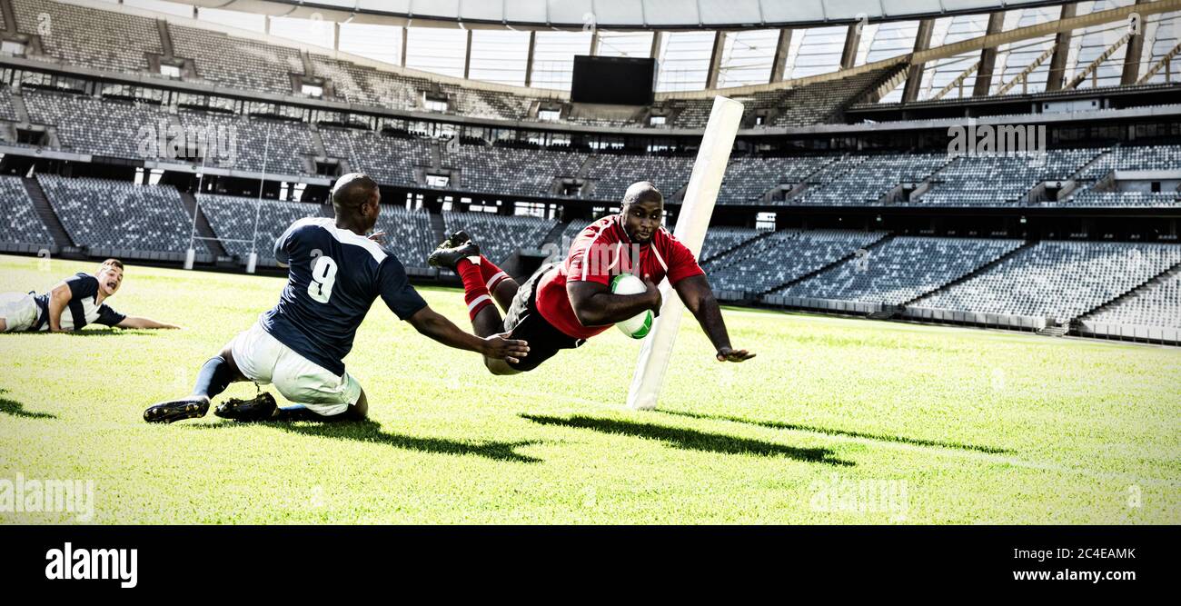 Digital composite image of rugby player jumping with the ball to score ...