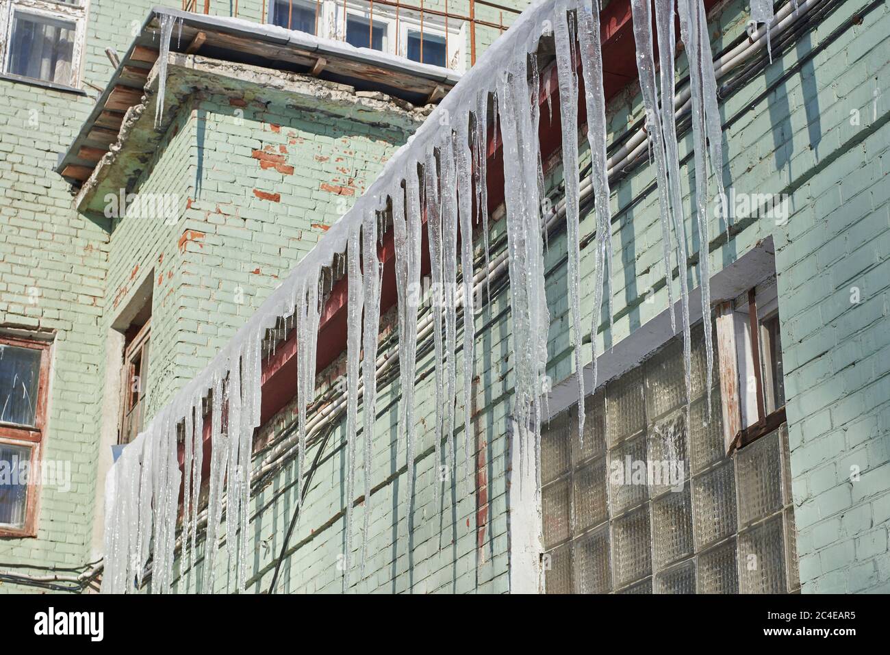 Large and dangerous icicles hang on the building Stock Photo - Alamy
