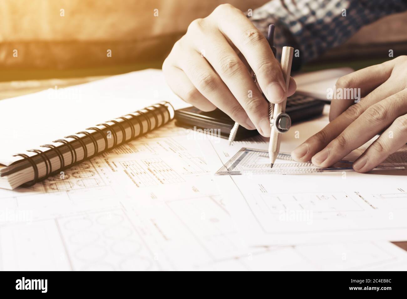 Architect man drawing geometric shape on sheet of paper at office table ...
