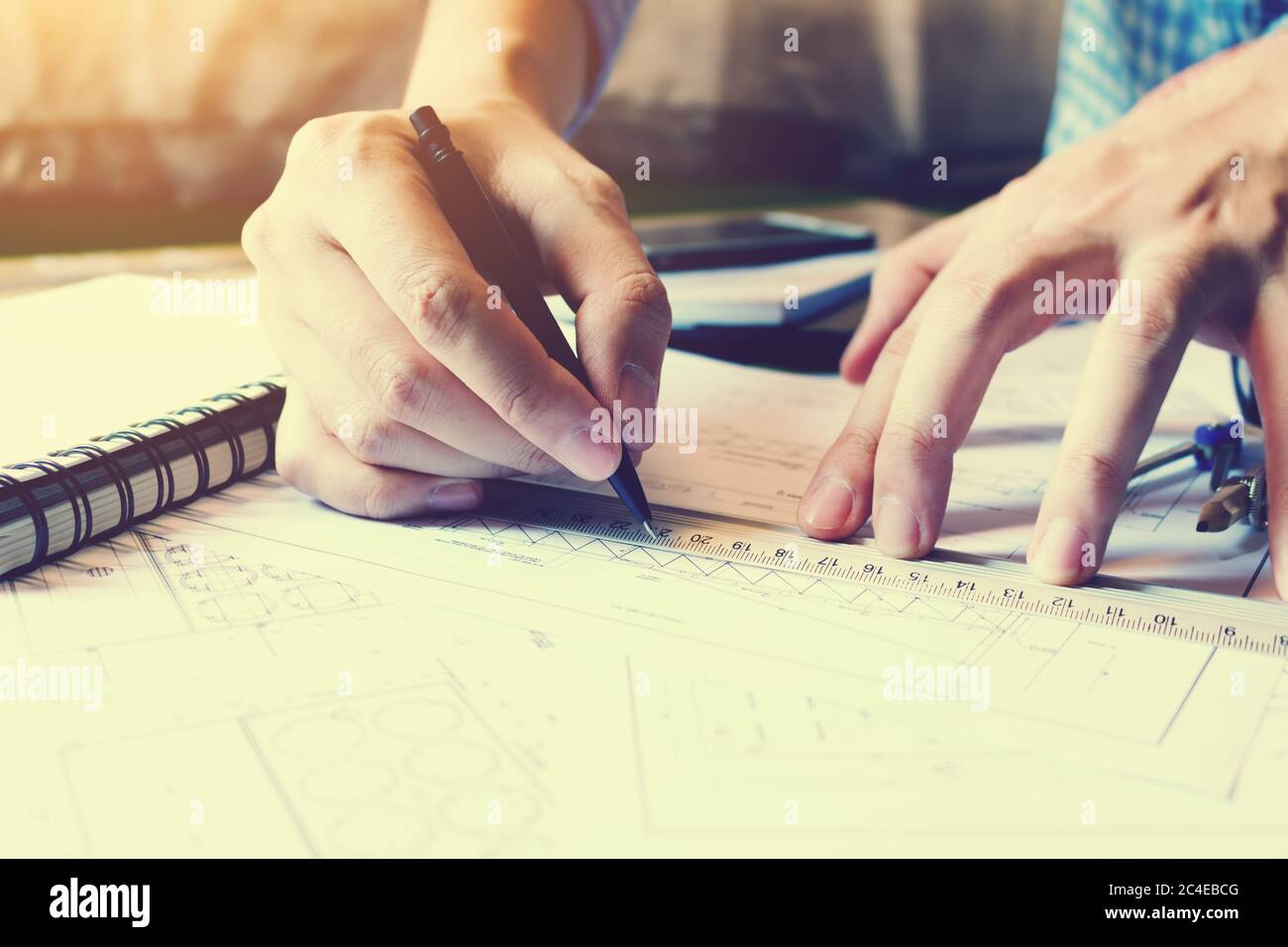 Architect man drawing geometric shape on sheet of paper at office table ...