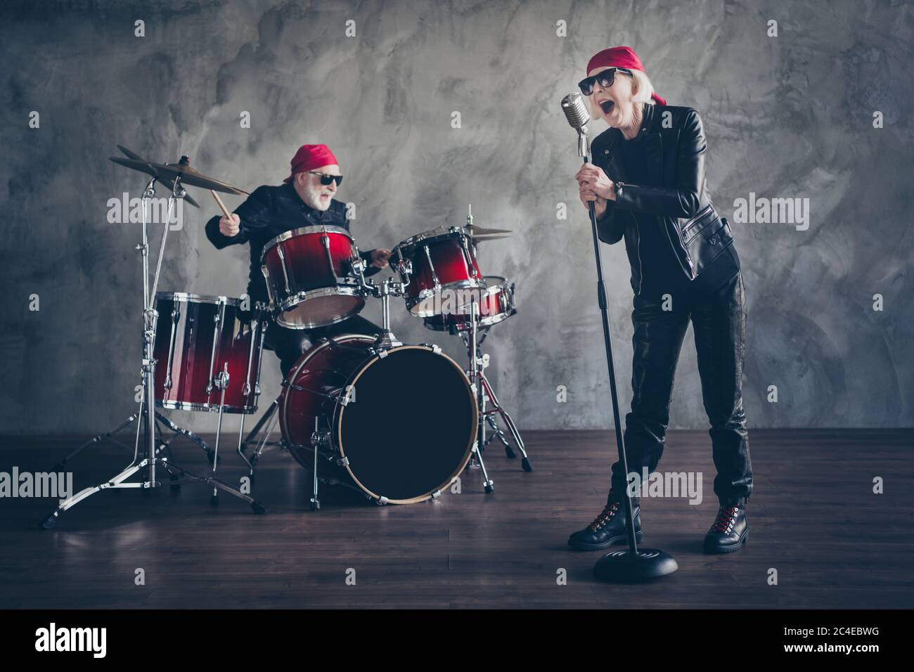 Full body photo of retired lady man rock popular band perform concert ...