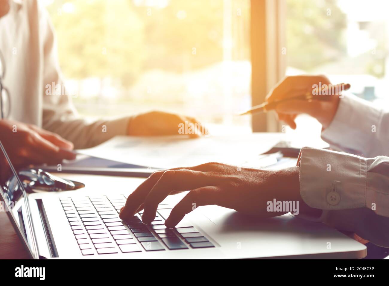 Two business people teamwork working near window in office room and ...
