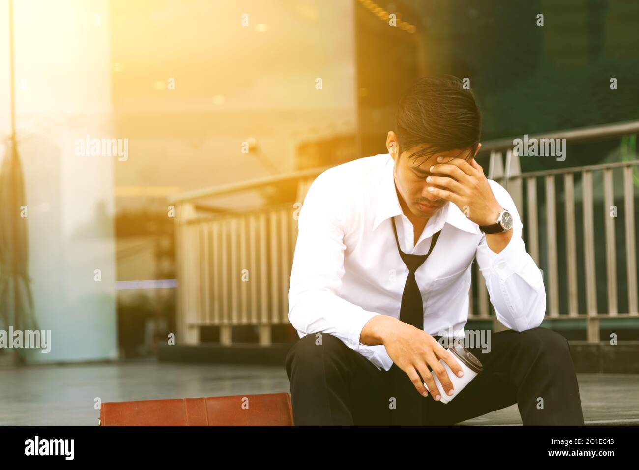 Business asian man sitting front company and stressed or worried bout ...