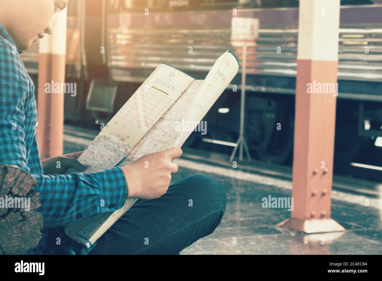 Asian man holding map and finding place location for travel at train ...