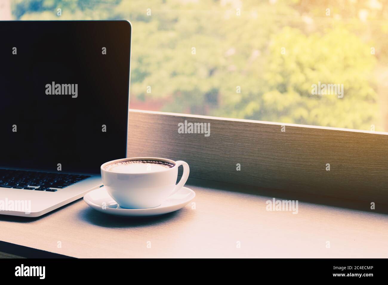 Coffee and laptop on desk bar in cafe with drink in morning Stock Photo ...