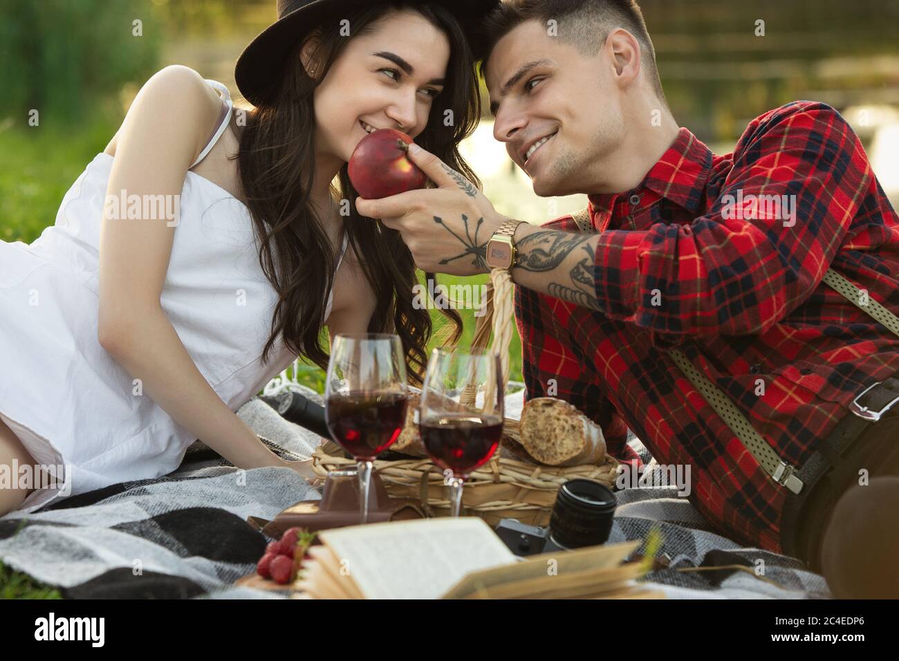 Drinking wine, close up. Caucasian young, happy couple enjoying weekend ...