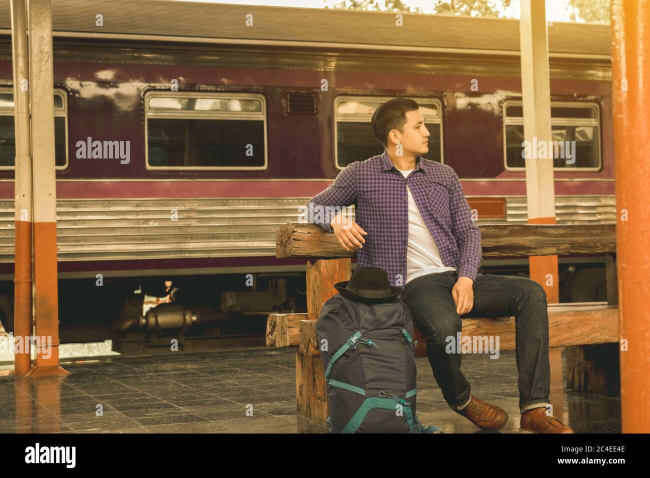 Lonely man waiting train at train station Stock Photo - Alamy