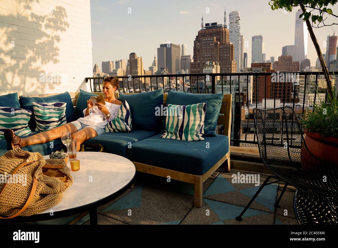 Woman relaxing on roof top hi-res stock photography and images - Alamy