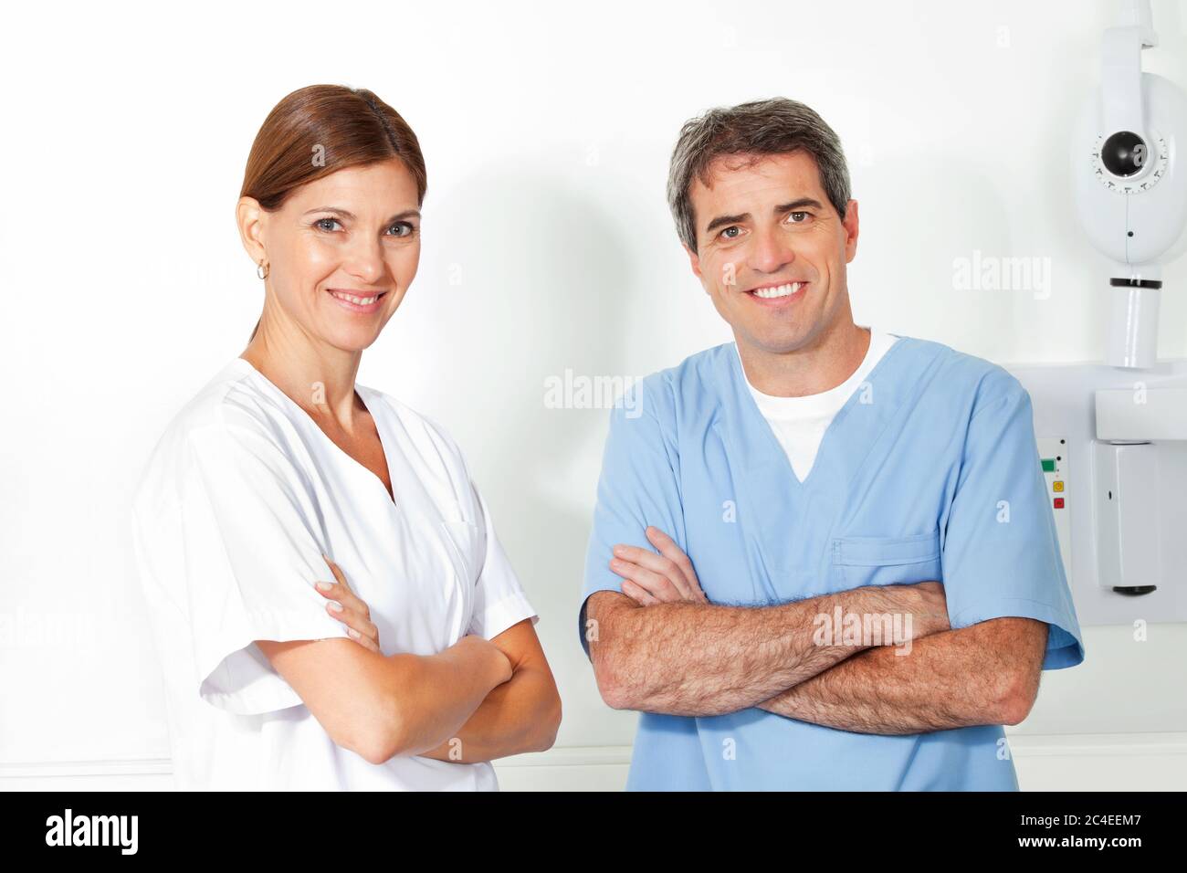 Two happy doctors with crossed arms Stock Photo - Alamy